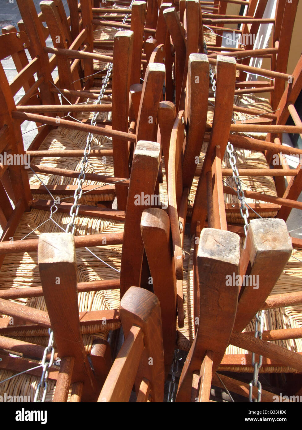 stack of wooden chairs locked with chain outdoors Stock Photo - Alamy