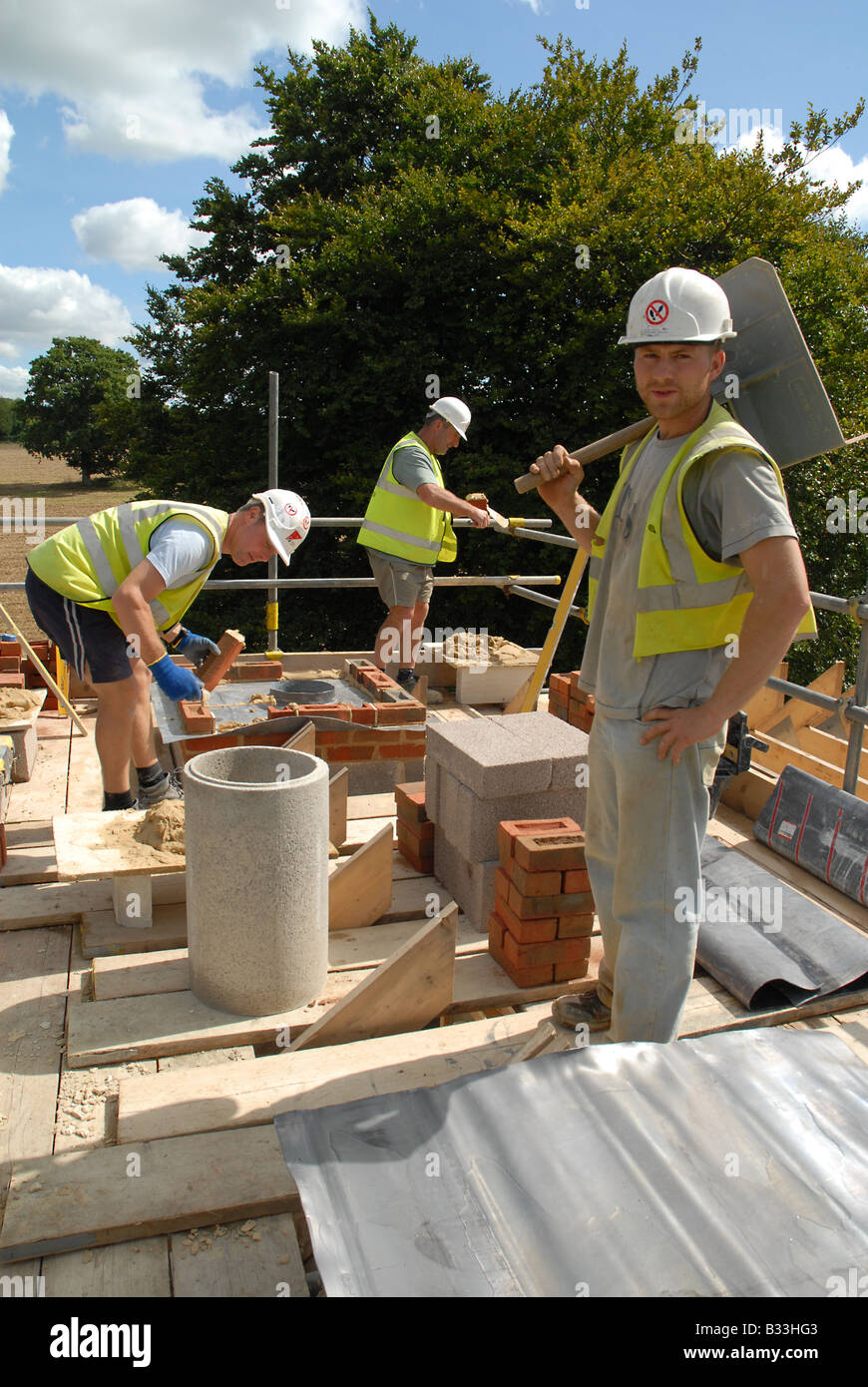 Workmen on the roof of a building site Stock Photo - Alamy