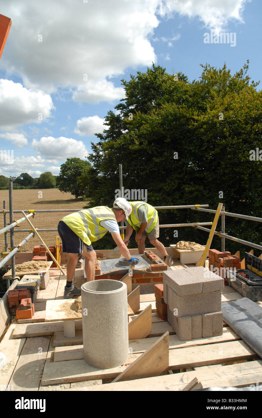 Workmen on the roof of a building site Stock Photo - Alamy