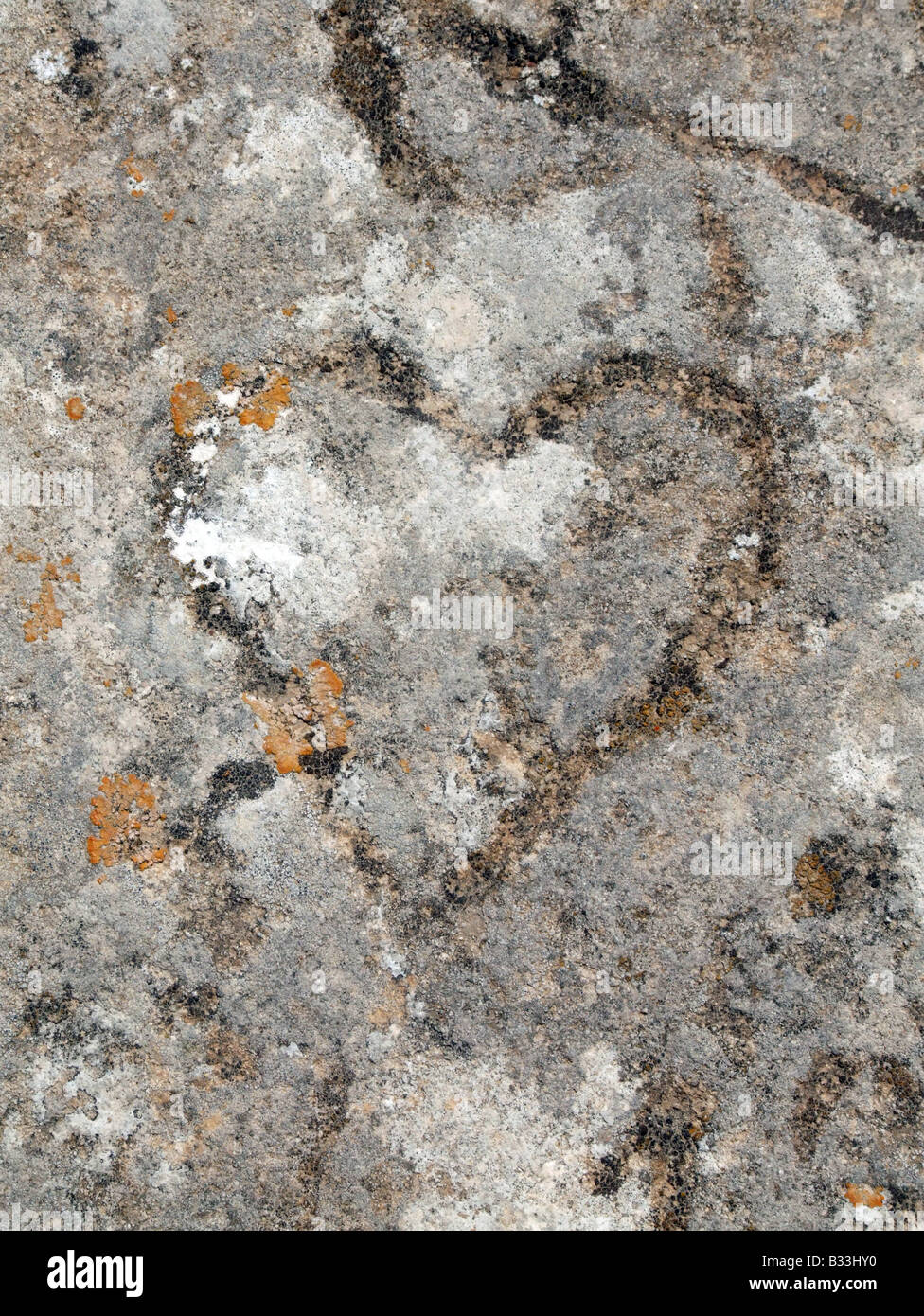 one old heart carved into stone wall in sun Stock Photo - Alamy