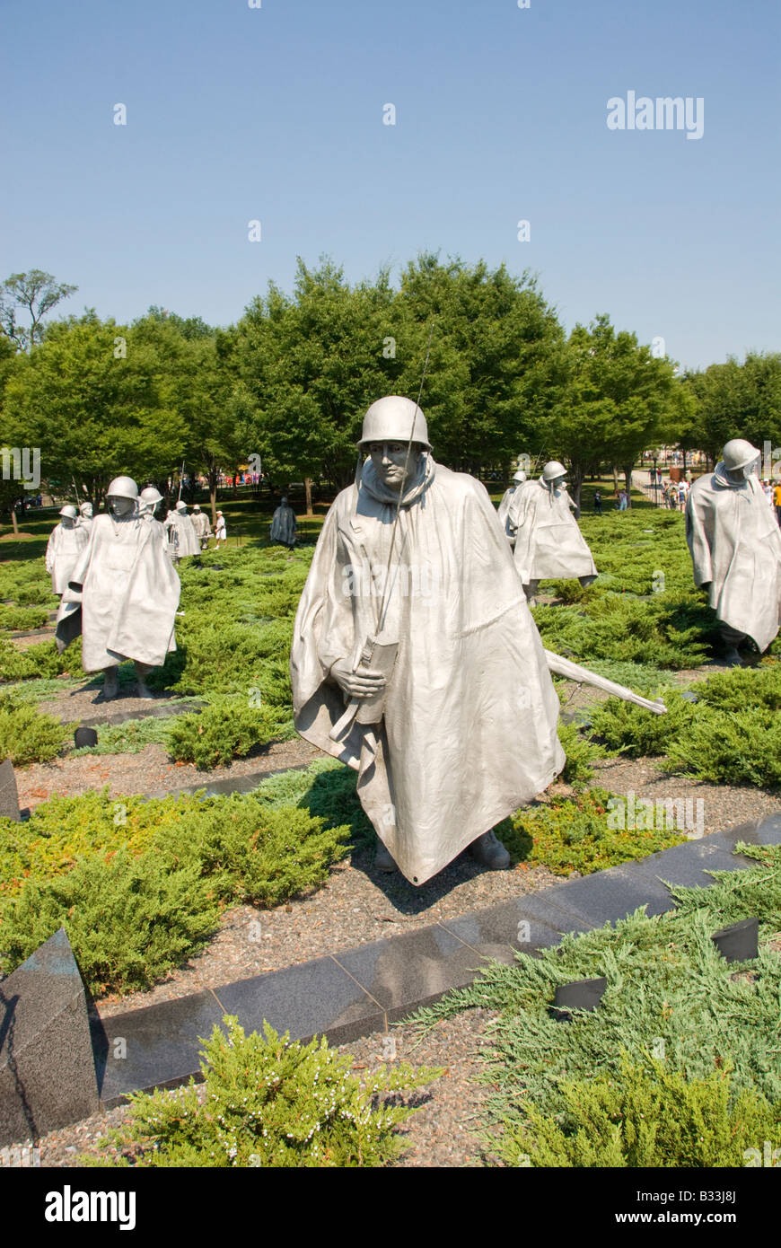 The statues of soldiers in a platoon march warily across a field at the ...