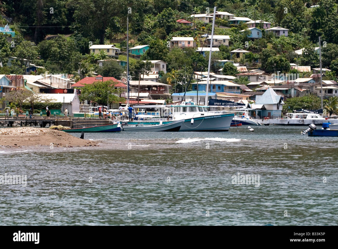 Waterside view looking onto Soufriere waterfront with boats and houses ...