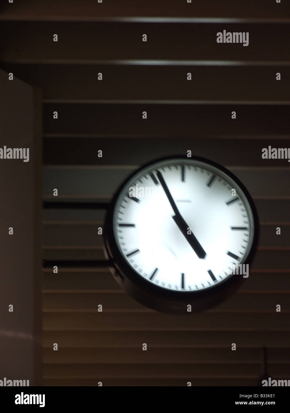 five to five on clock in city at night Stock Photo - Alamy