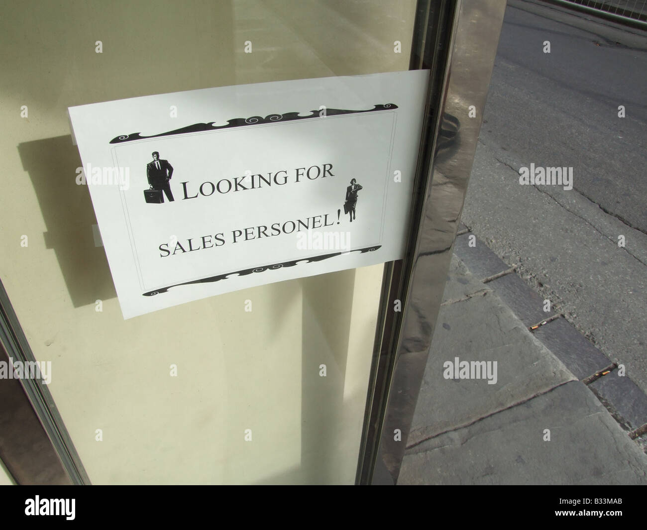 looking for staff notice in shop window Stock Photo - Alamy