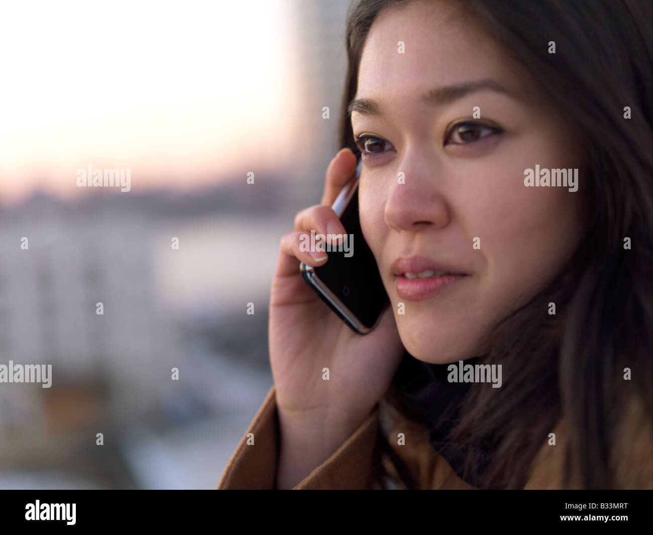 A young Chinese woman using her mobile phone Stock Photo - Alamy
