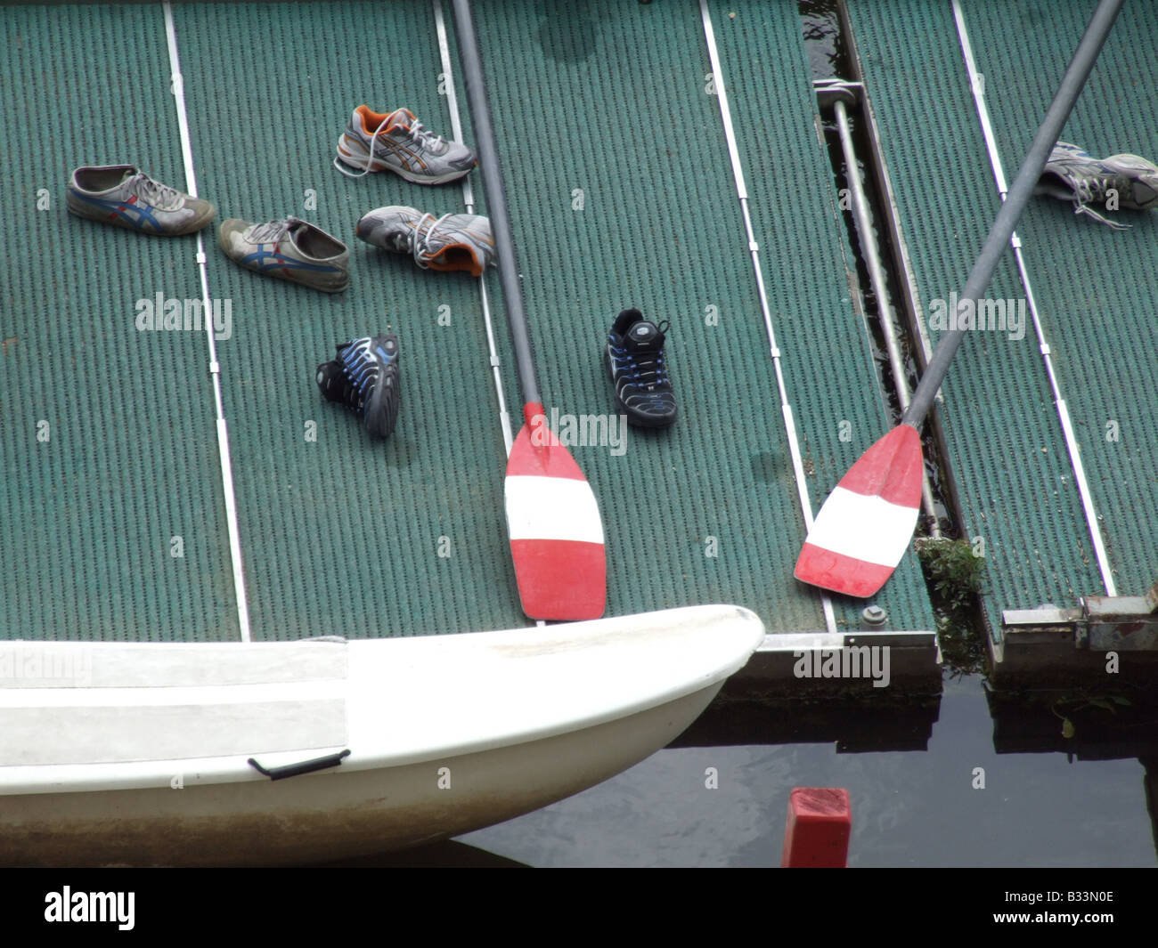 river rowing boat and oars on ground at club Stock Photo - Alamy