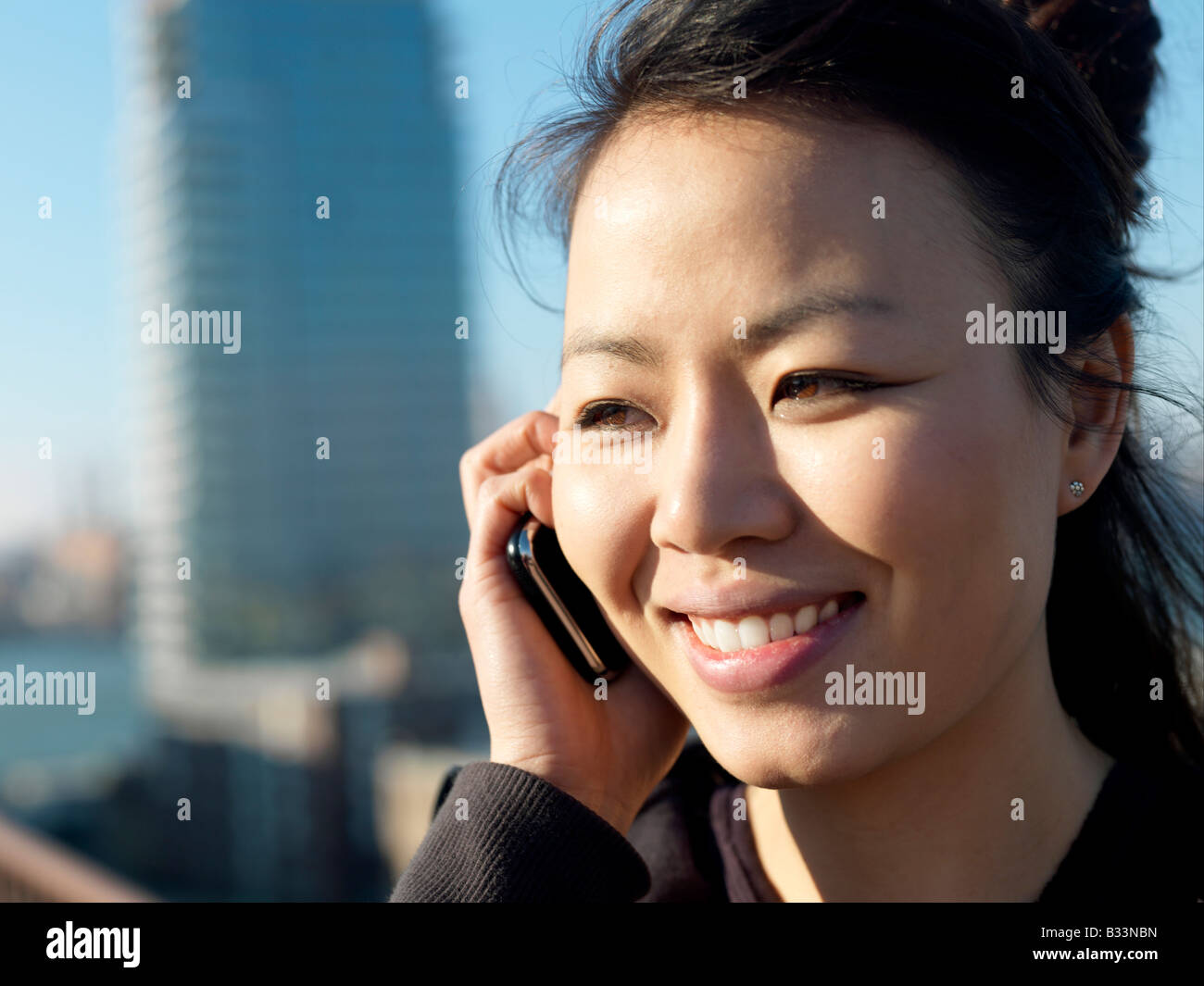 A Asian woman young women using her mobile phone Stock Photo - Alamy
