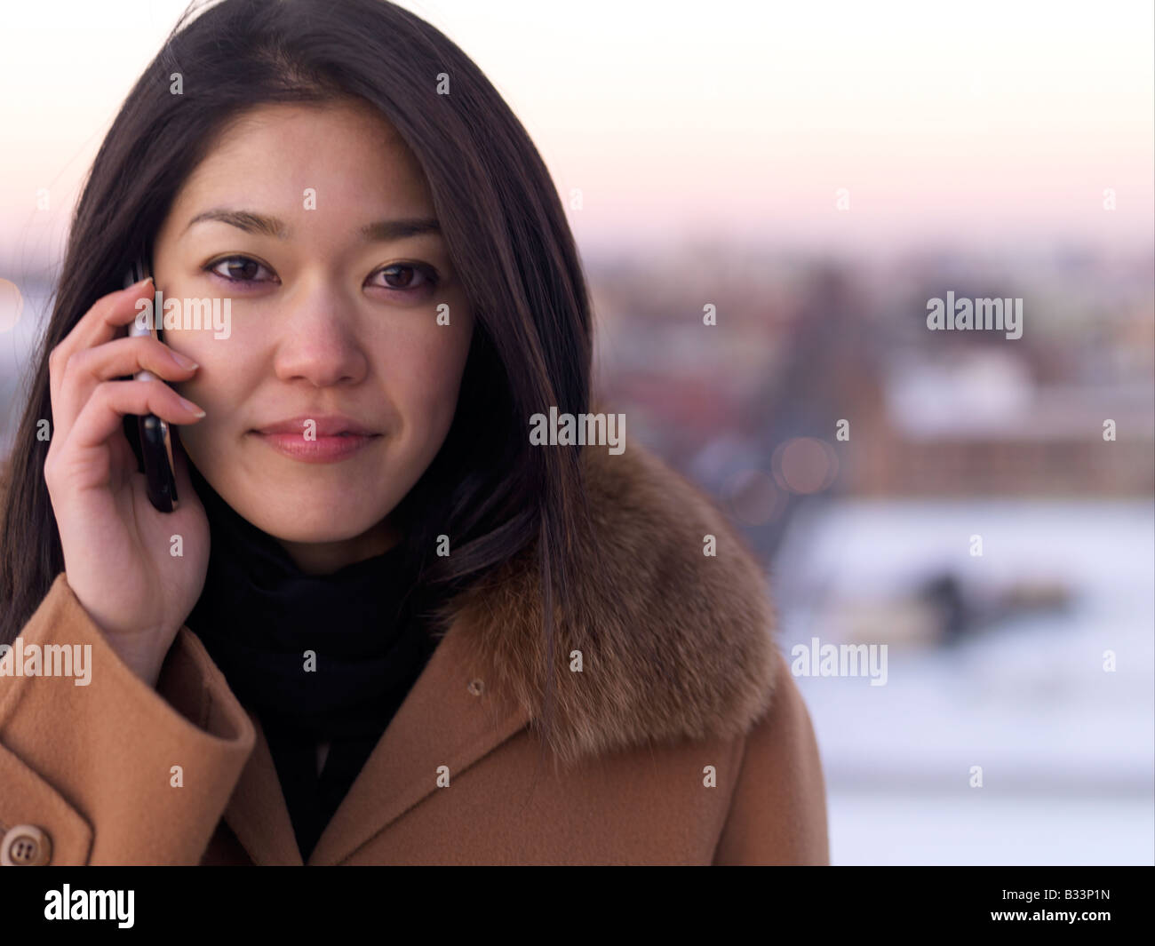 A young Chinese woman using her mobile phone Stock Photo - Alamy