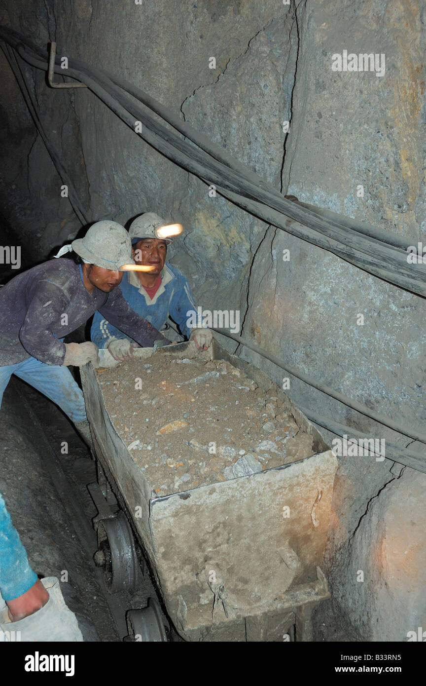 Miners pushing a full cart inside a mine Bolivia South America Stock ...
