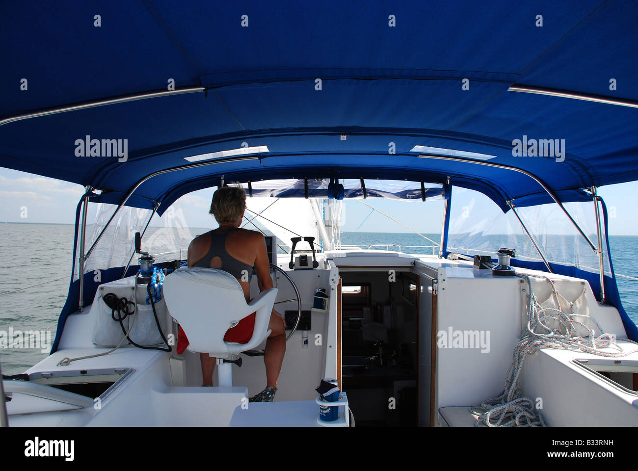 Woman sailor at the helm Stock Photo - Alamy
