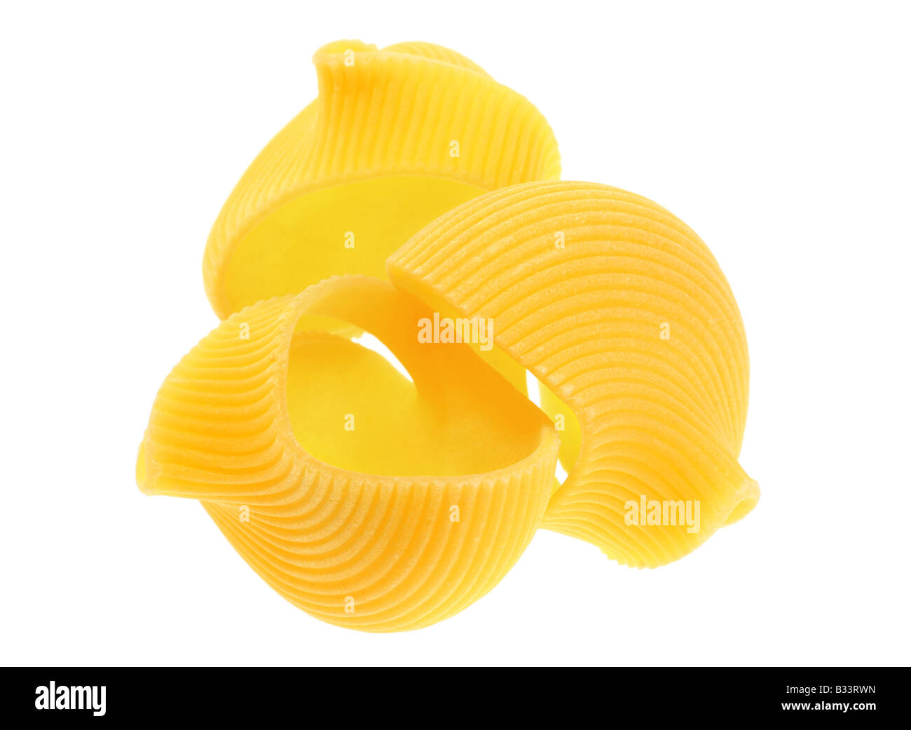 Big yellow pasta isolated on white background Stock Photo - Alamy
