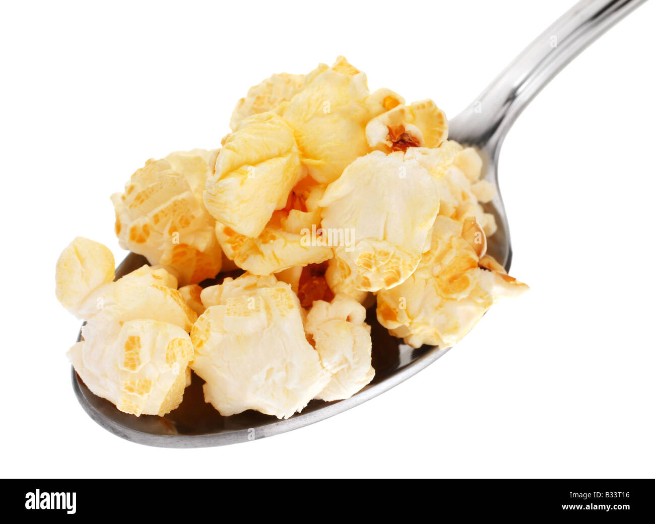 Popcorn in metal spoon on white background Stock Photo - Alamy
