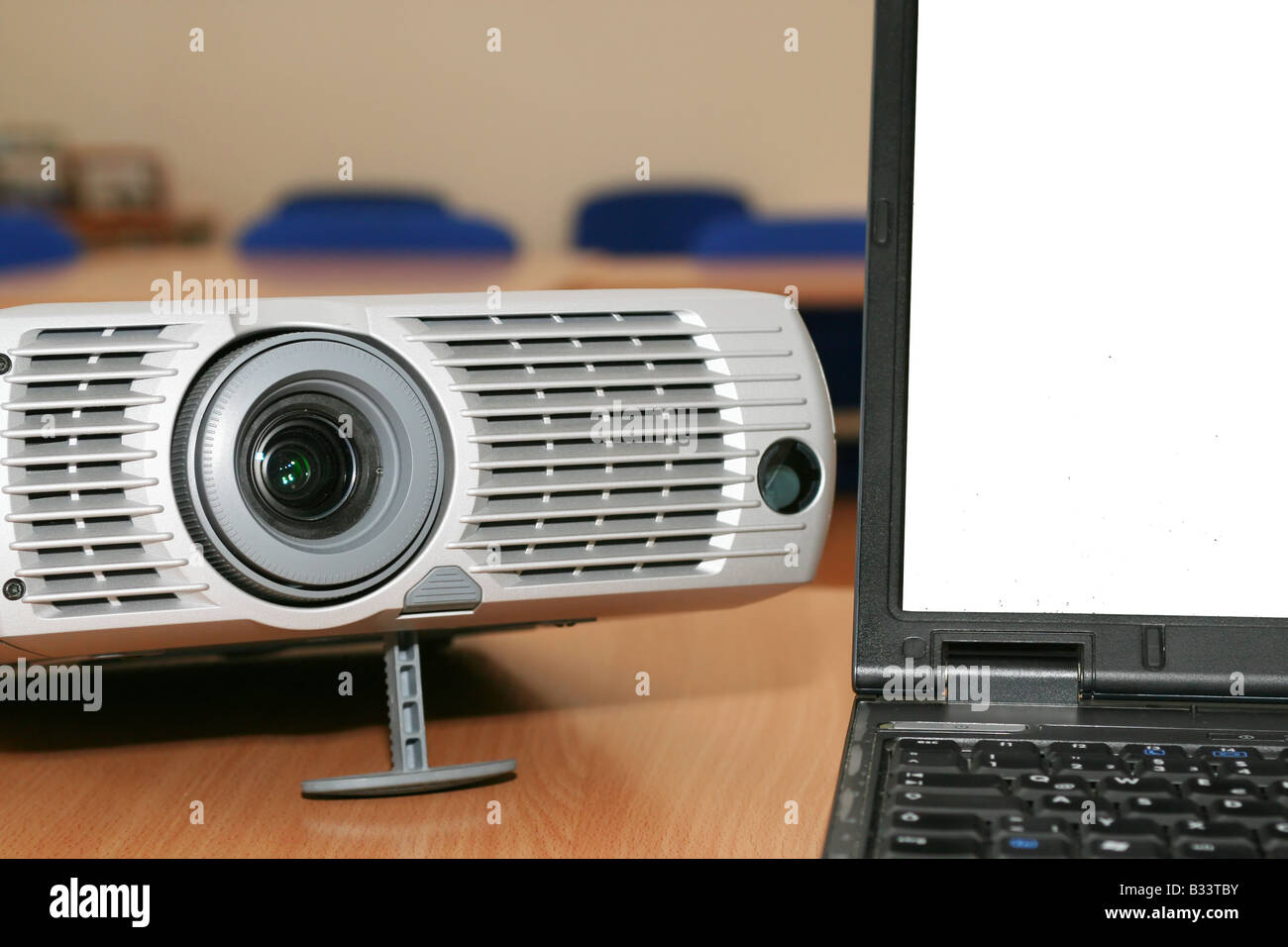Laptop with the projector on office table Stock Photo - Alamy