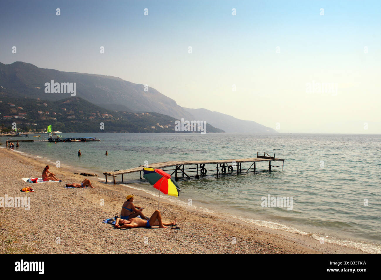 THE SANDY BEACH AT THE RESORT OF IPSOS ON THE EAST COAST OF CORFU ...