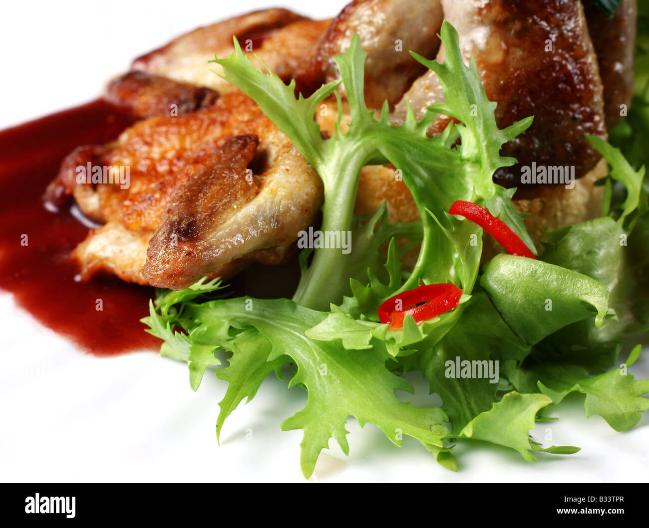 Quail fried meat wth sauce on white plate Stock Photo - Alamy