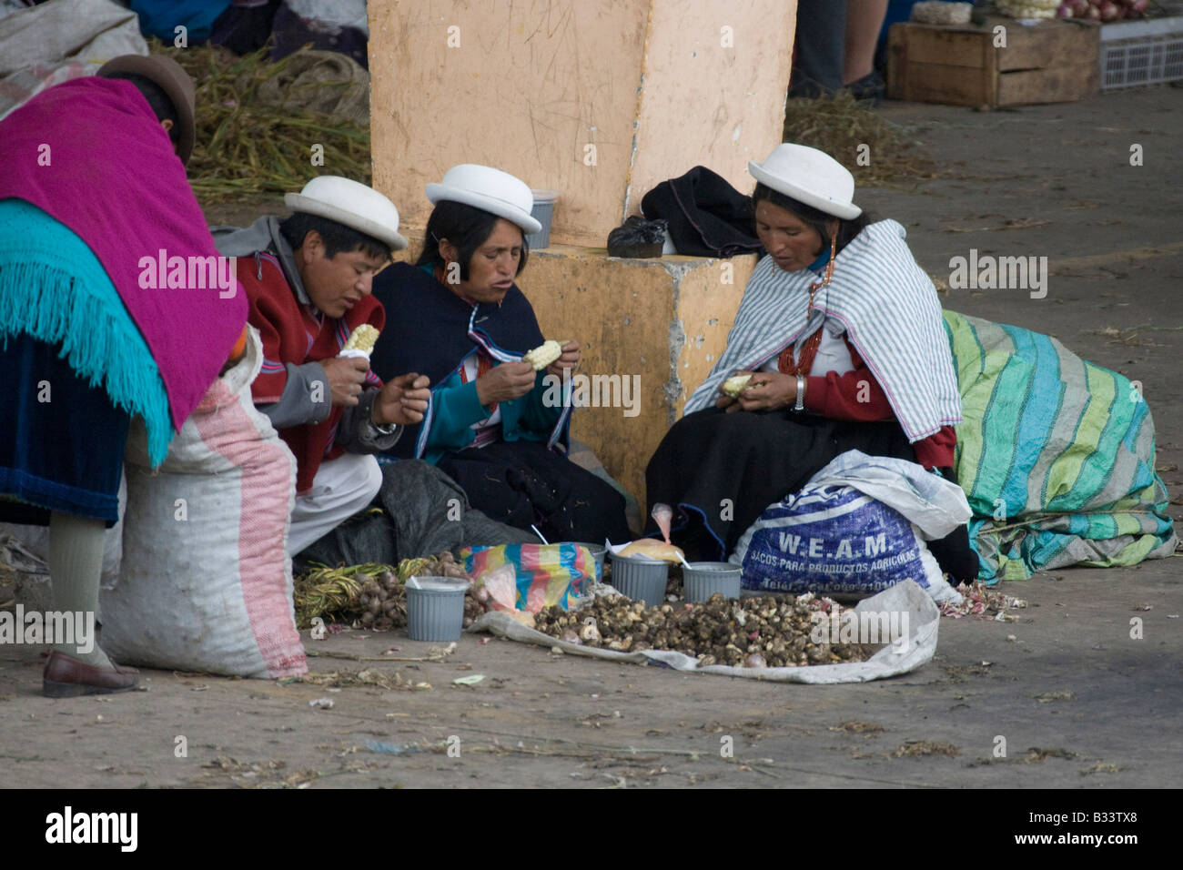 Woman in white hats and poncho,Guamote market, indian farmer andes ...