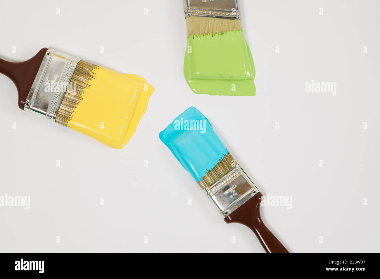 Three paint brushes with wet paint Stock Photo - Alamy