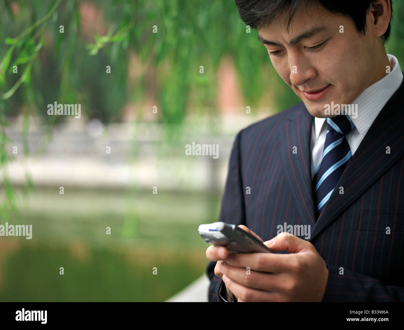 Chinese Businessman utilizing technology for business purposes Stock ...