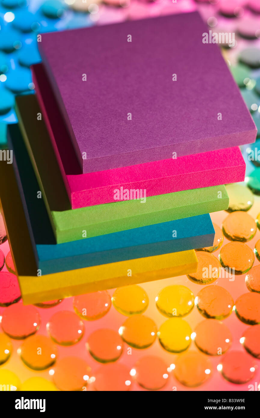 Stack of colored note pads with glass bead background Stock Photo - Alamy