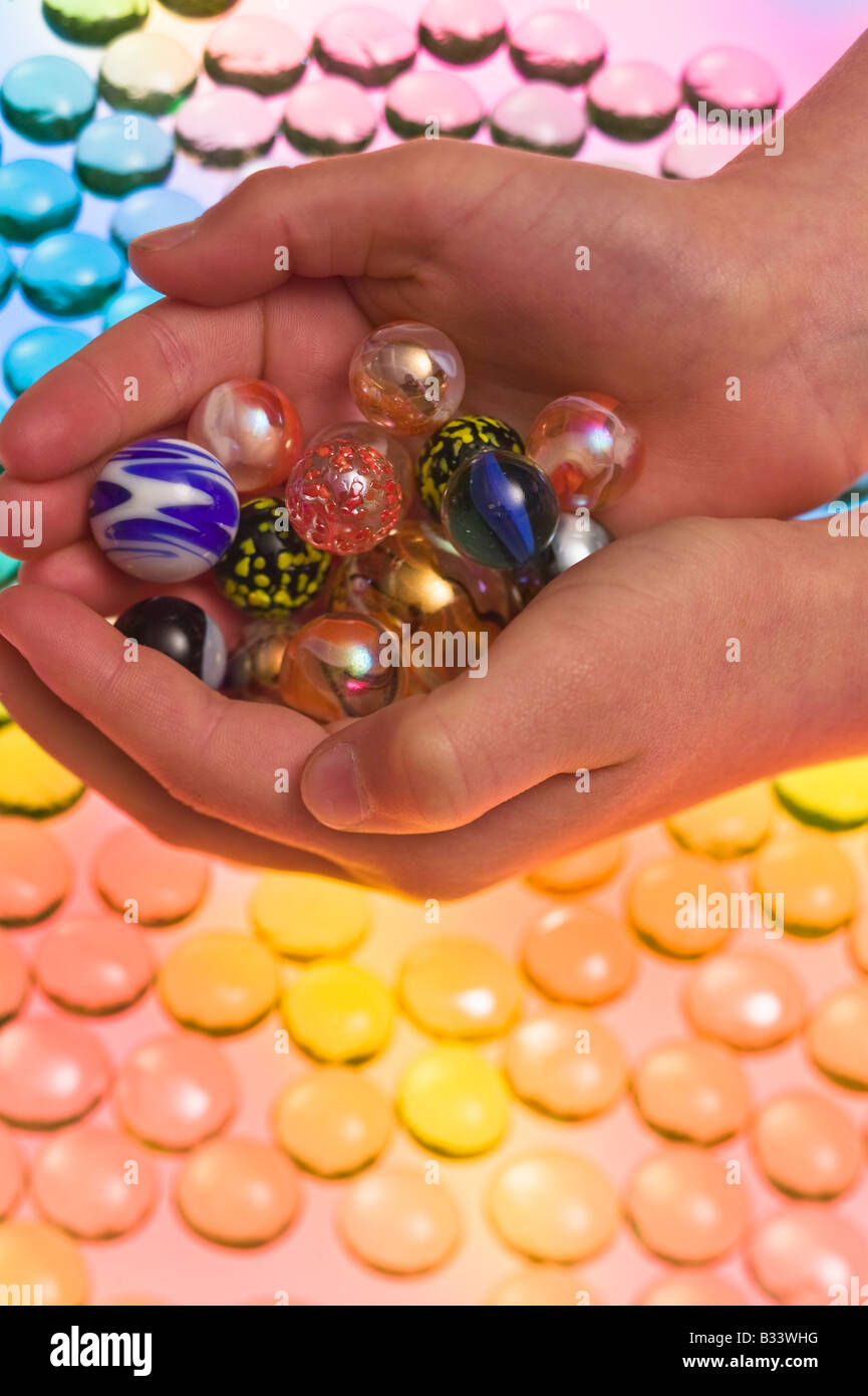 Hand holding marbles hi-res stock photography and images - Alamy