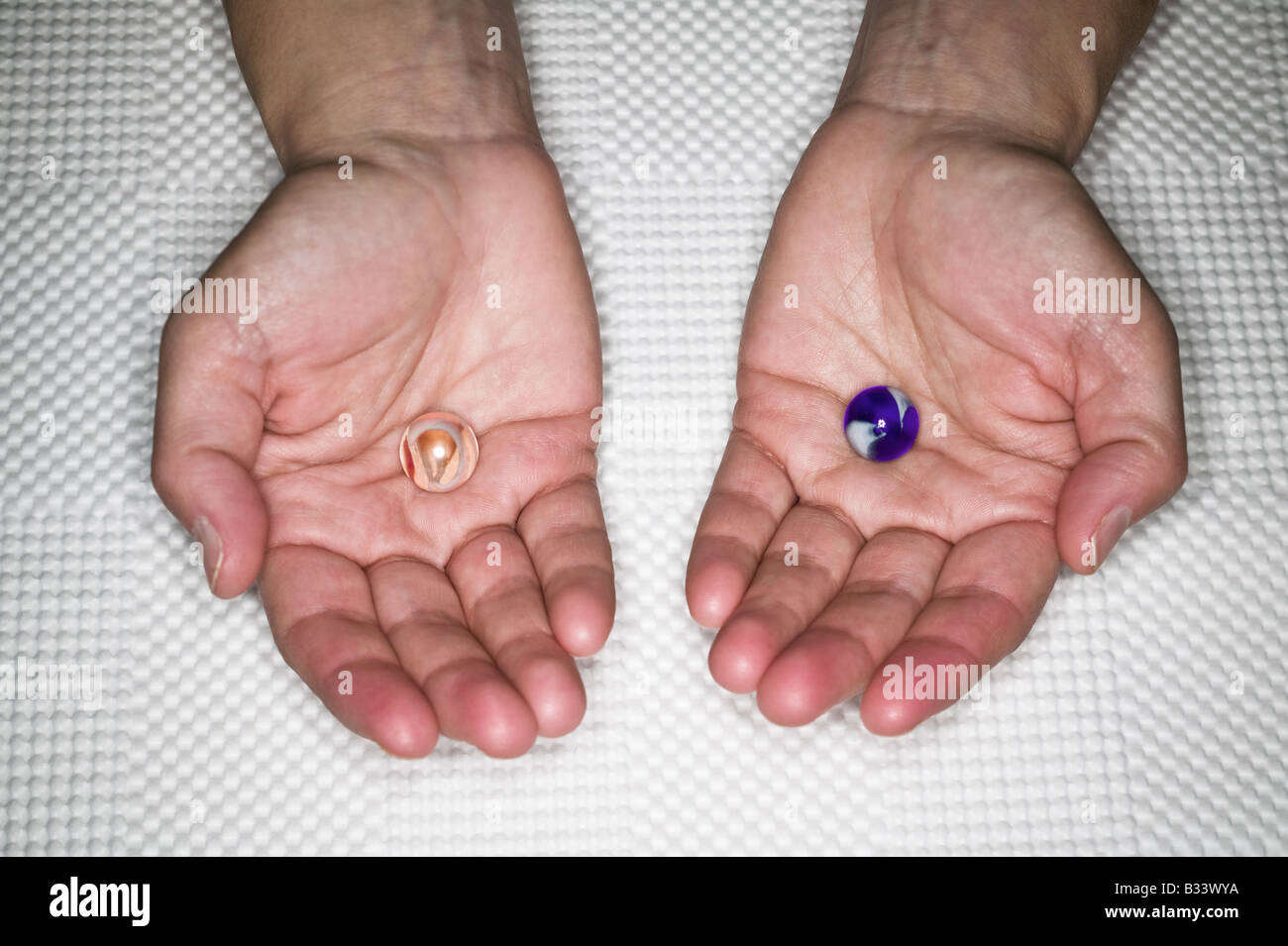 Hand holding marbles hi-res stock photography and images - Alamy