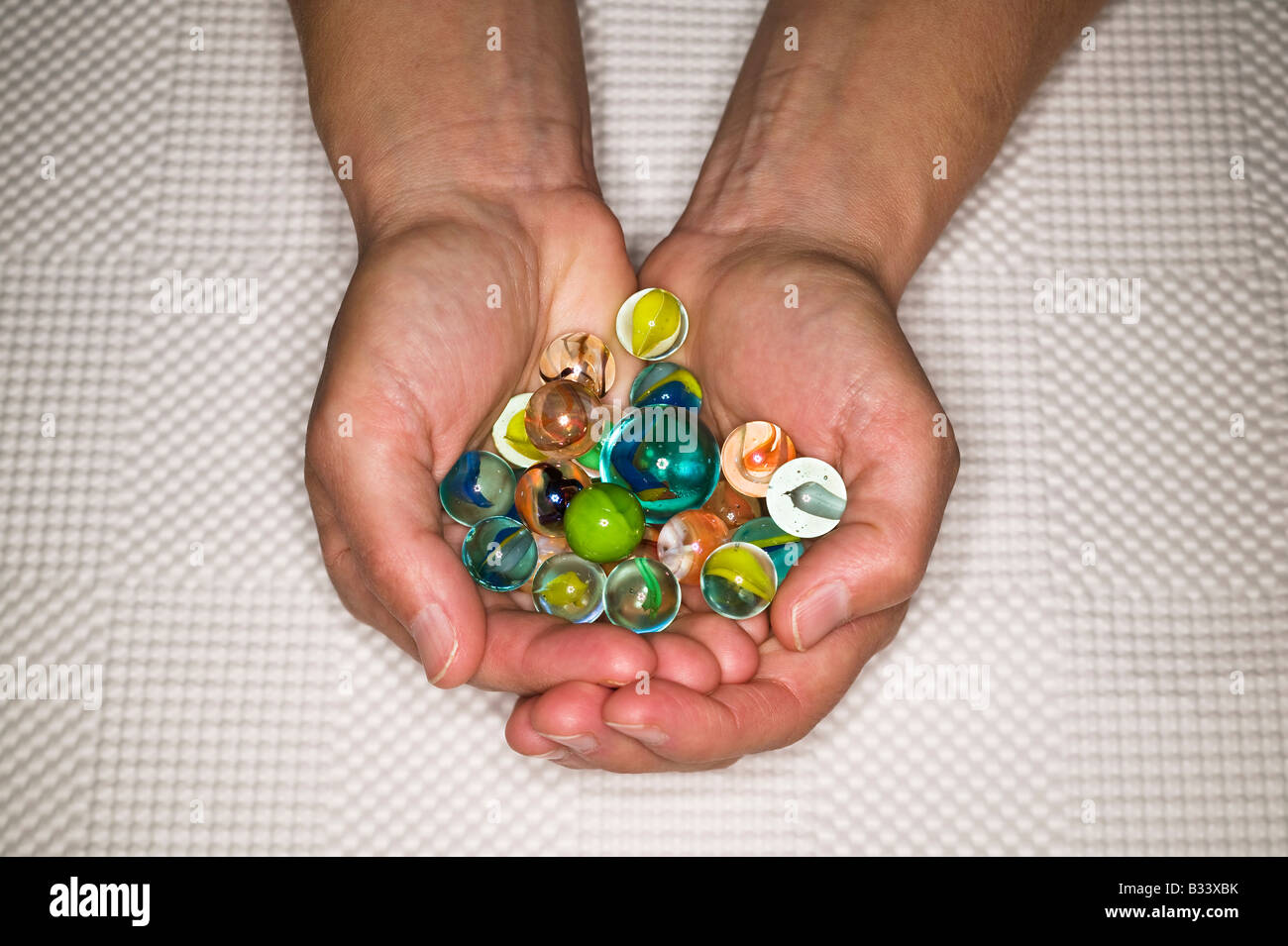 Hand holding marbles hi-res stock photography and images - Alamy
