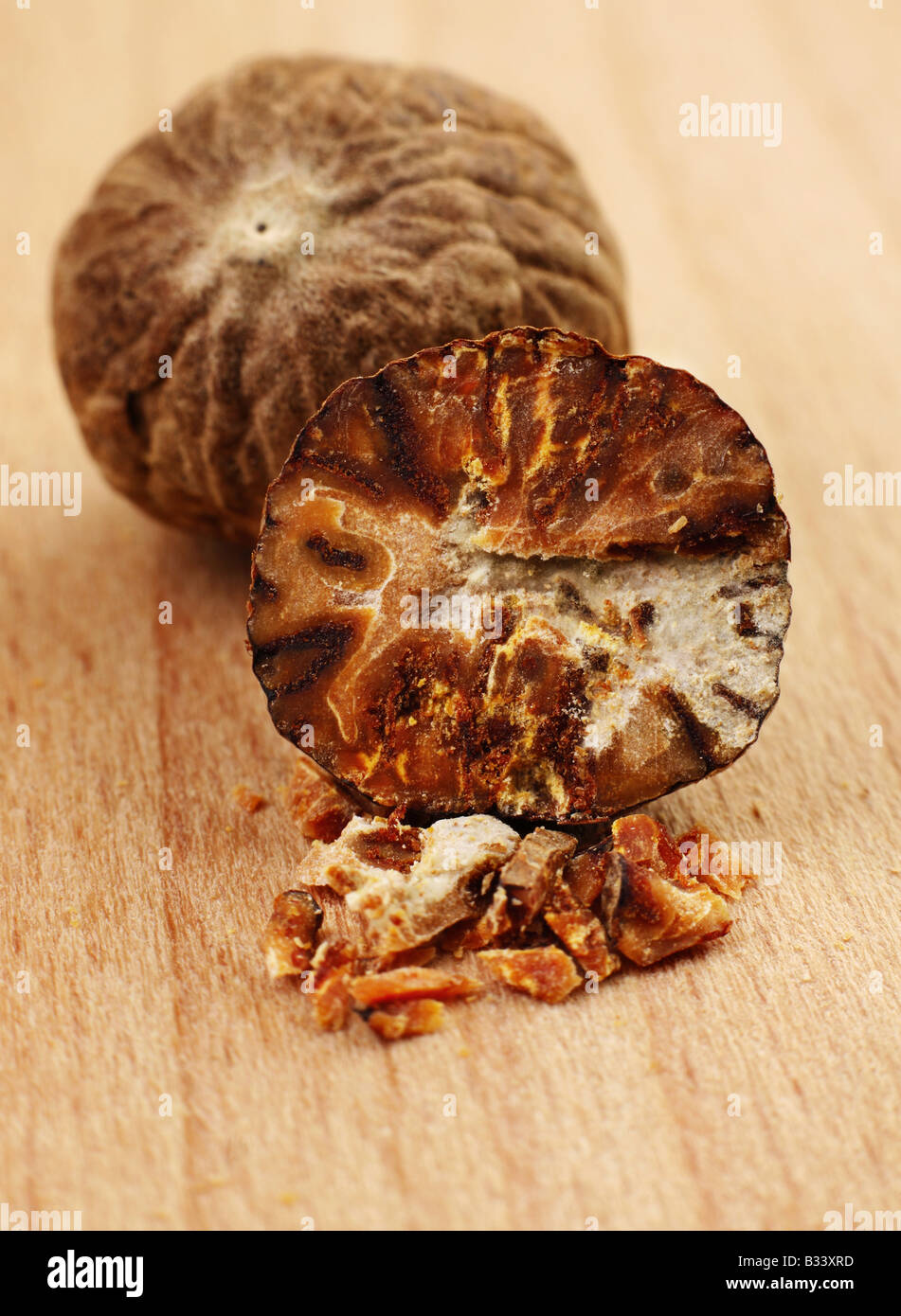 Nutmeg spice with broken part on wood table Stock Photo - Alamy