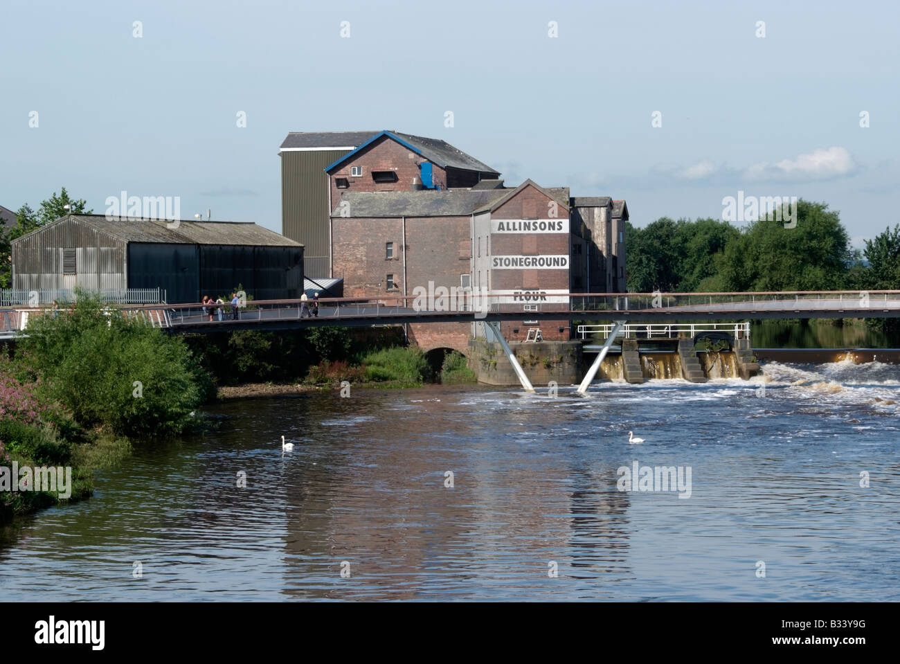 The new footbridge adjacent to the flour mill and the weir between Aire ...