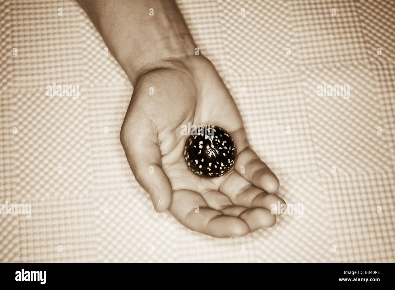Hand holding a glass marble Stock Photo - Alamy