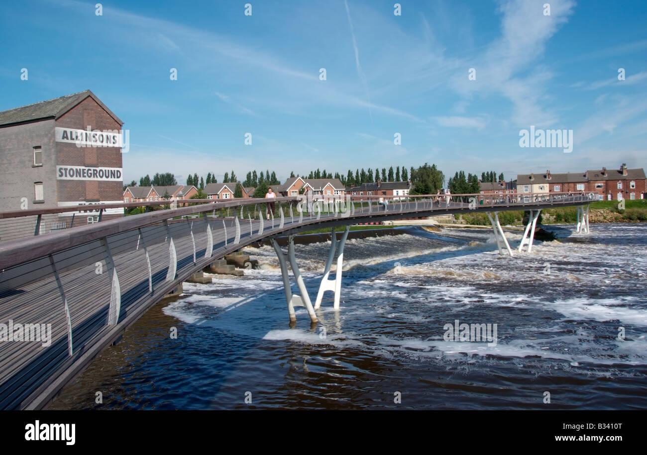 The new footbridge adjacent to the flour mill and the weir between Aire ...