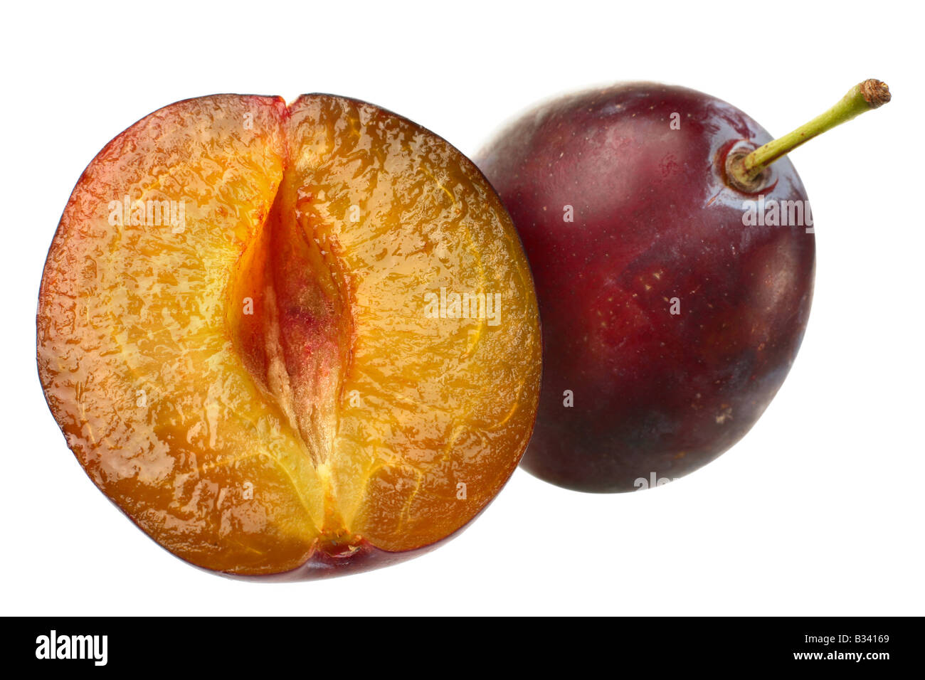 Detail plum with slice on white background Stock Photo - Alamy