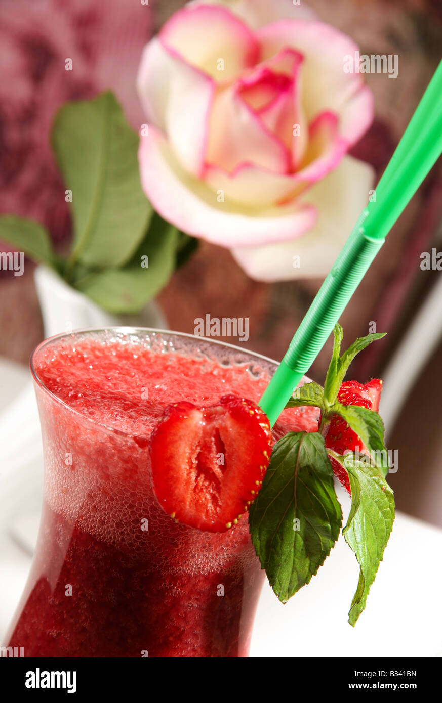 Strawberry fresh red cocktail with rose flower Stock Photo - Alamy