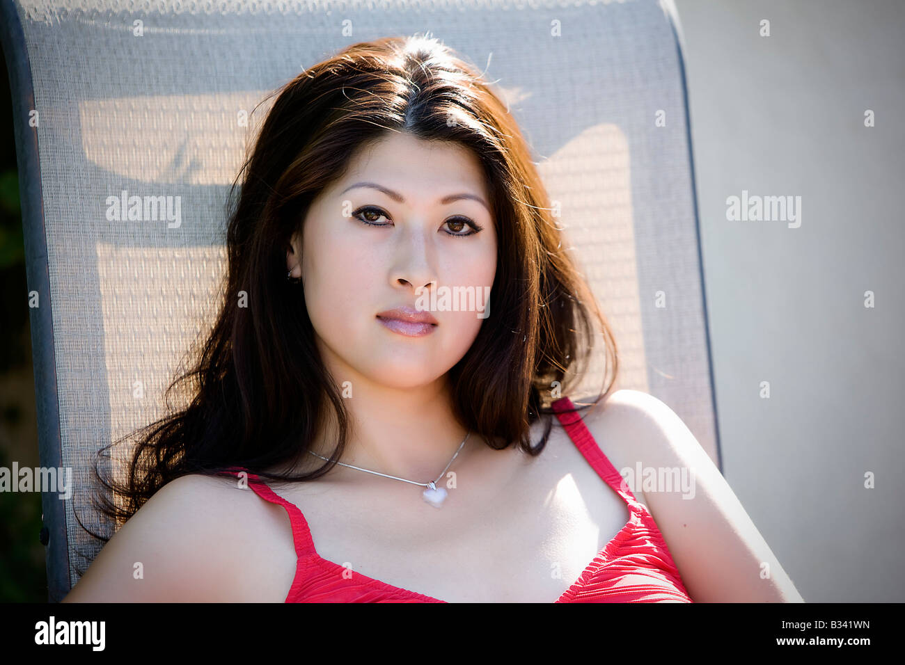 Asian Female Model Lounge Chair Stock Photo - Alamy