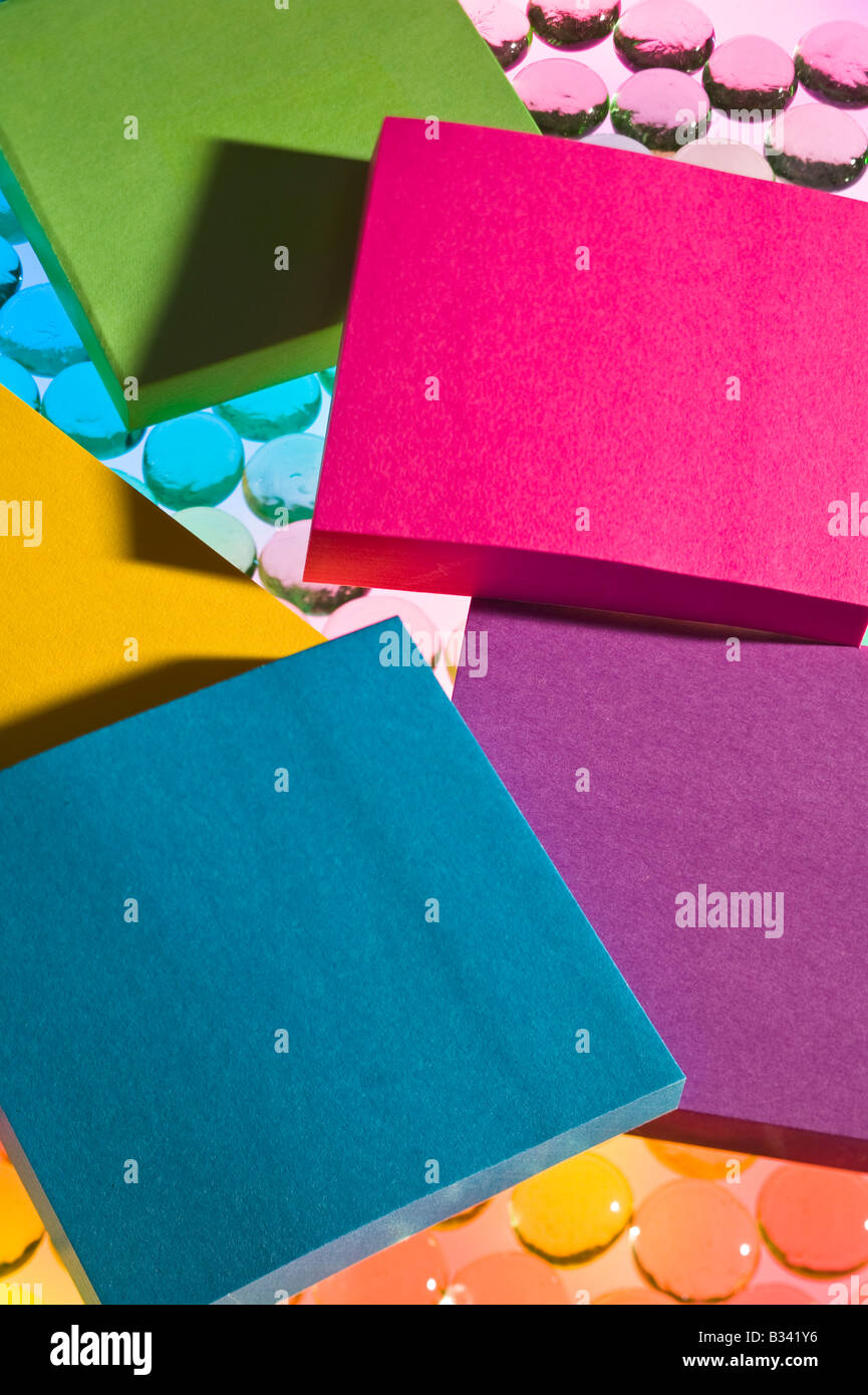 Stack of colored note pads with glass bead background Stock Photo - Alamy