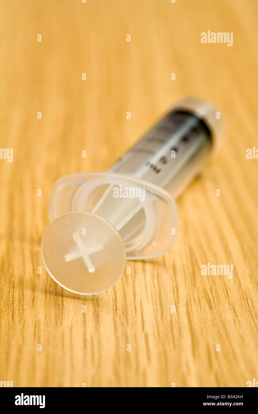 An empty syringe on a table, UK Stock Photo - Alamy