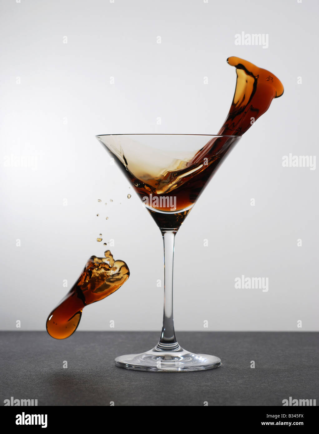 High-speed cocktail glass splash Stock Photo - Alamy