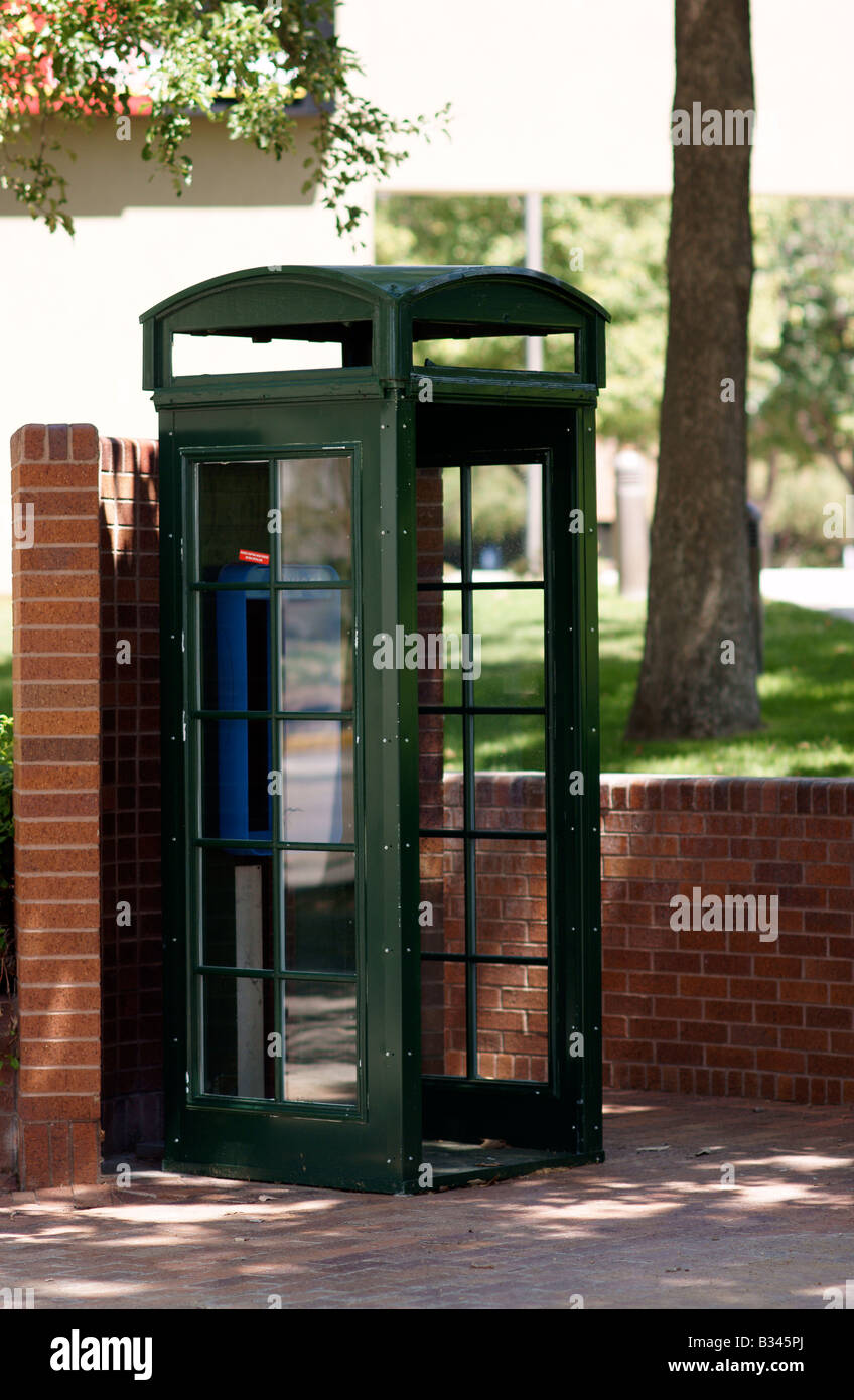 An older abandoned green public phone booth in an uptown district Stock ...