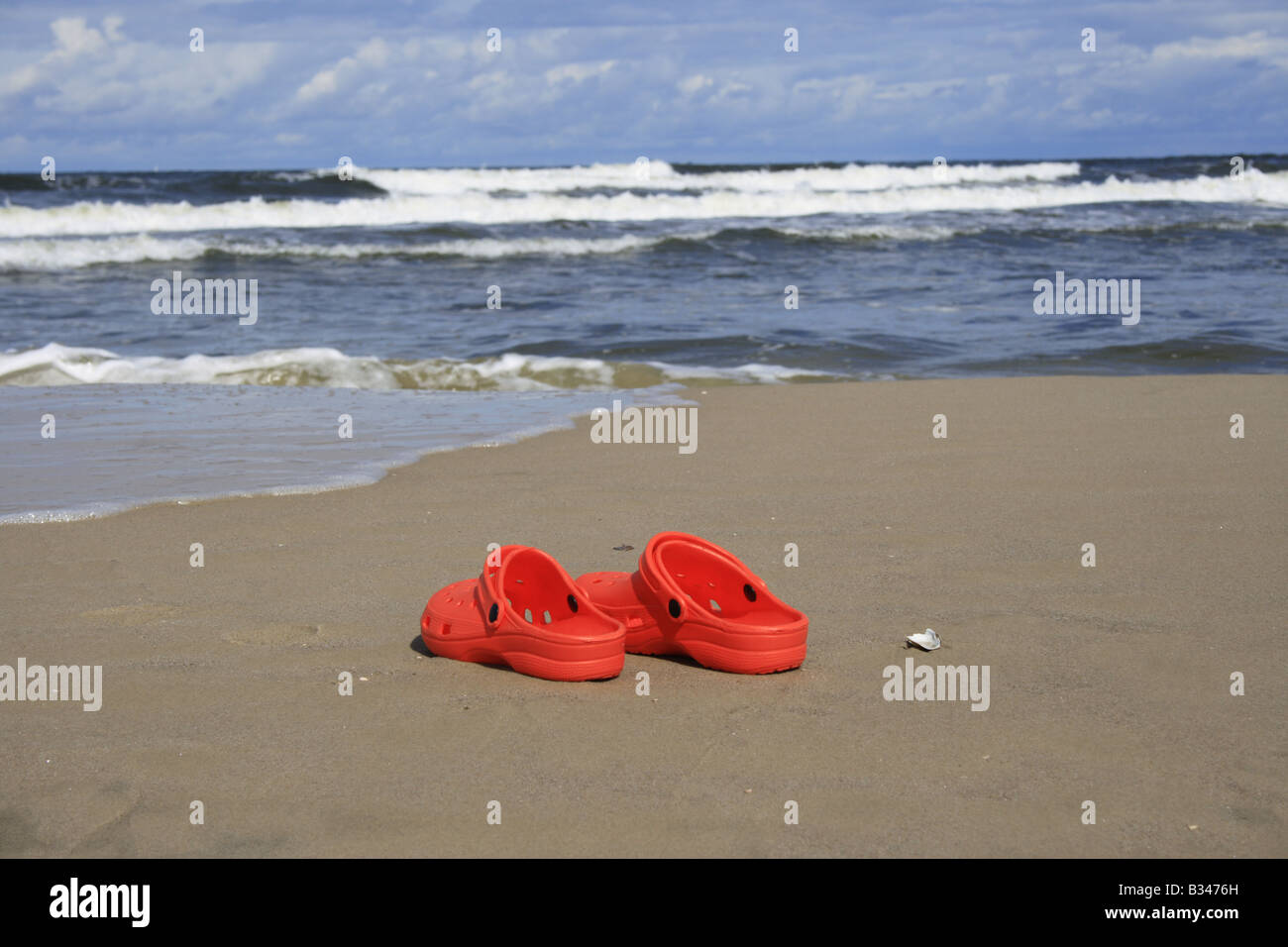 pair of red crocs at the sandy beach. Photo by Willy Matheisl Stock ...