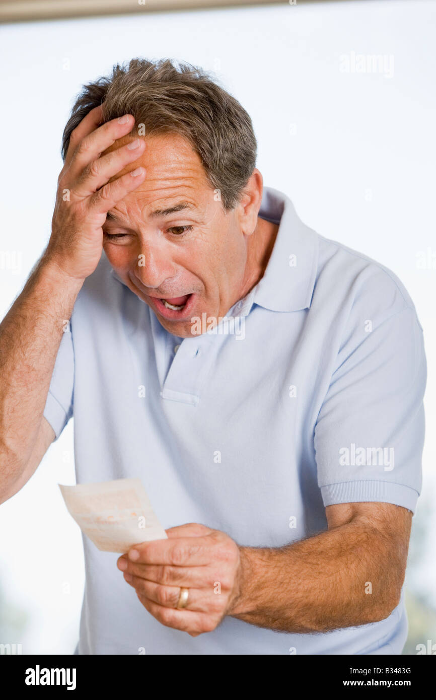 Man with winning lottery ticket excited and smiling Stock Photo - Alamy