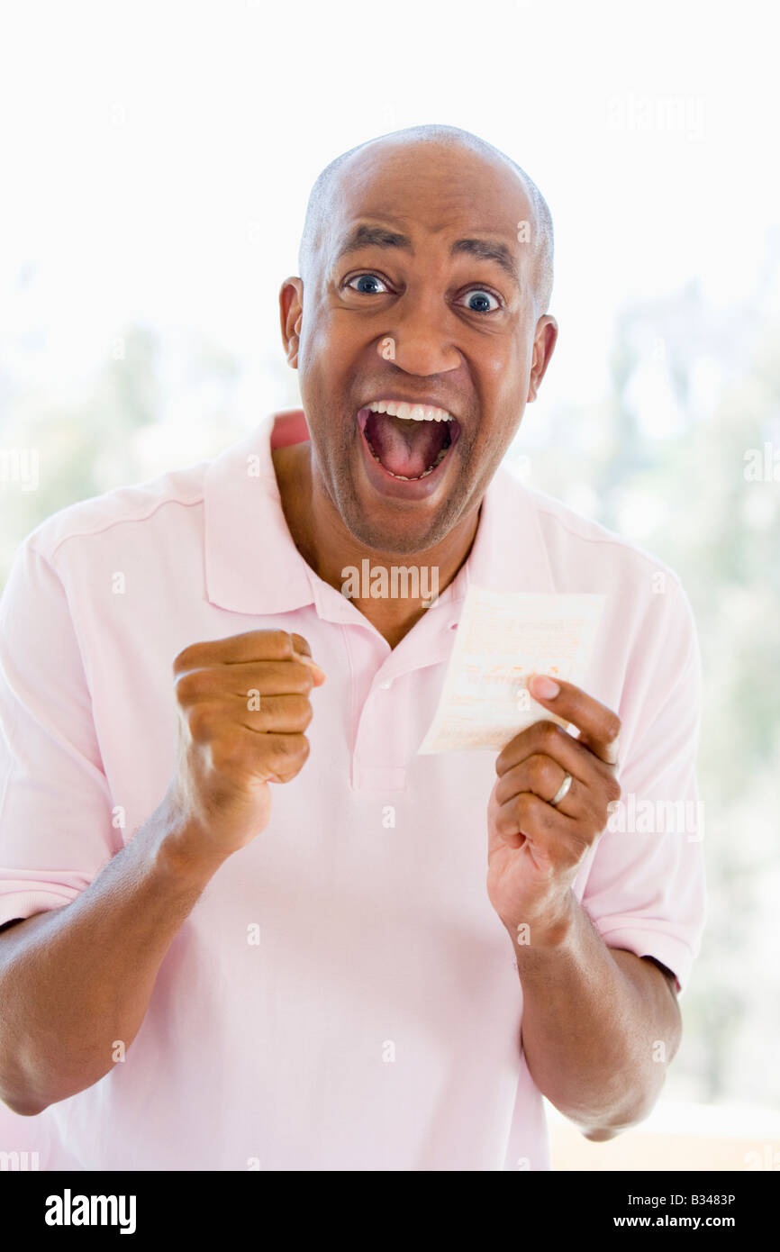 Man with winning lottery ticket excited and smiling Stock Photo - Alamy
