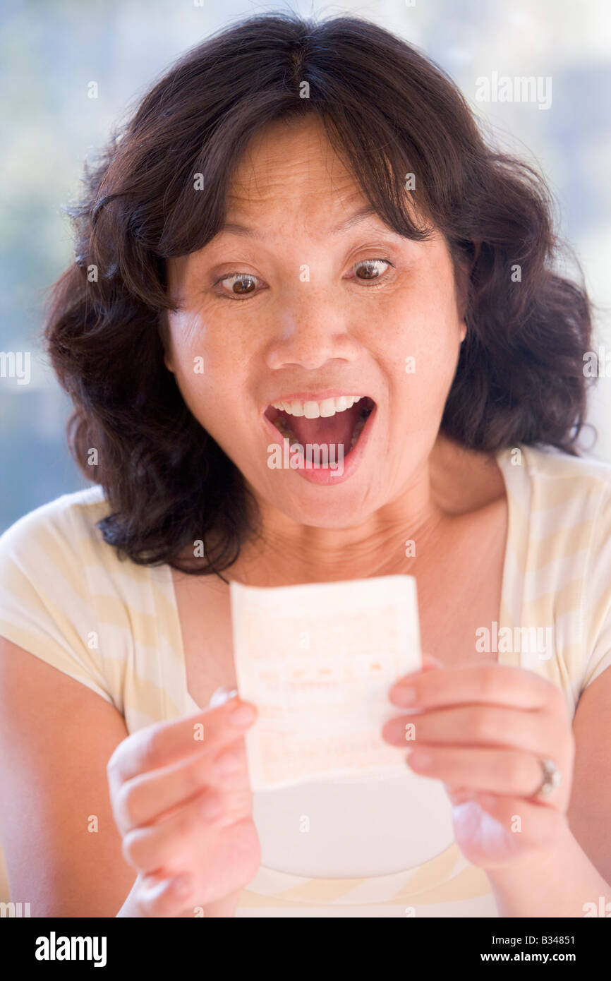 Woman with winning lottery ticket excited and smiling Stock Photo - Alamy