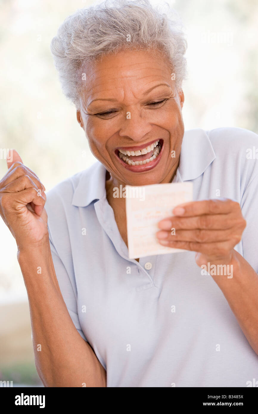 Woman with winning lottery ticket excited and smiling Stock Photo - Alamy