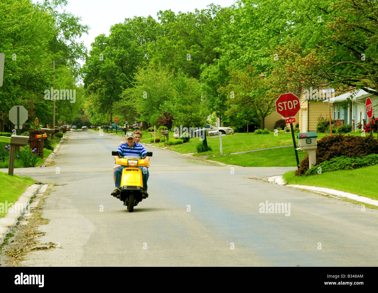 Family and yellow Yamaha scooter cycle Stock Photo - Alamy