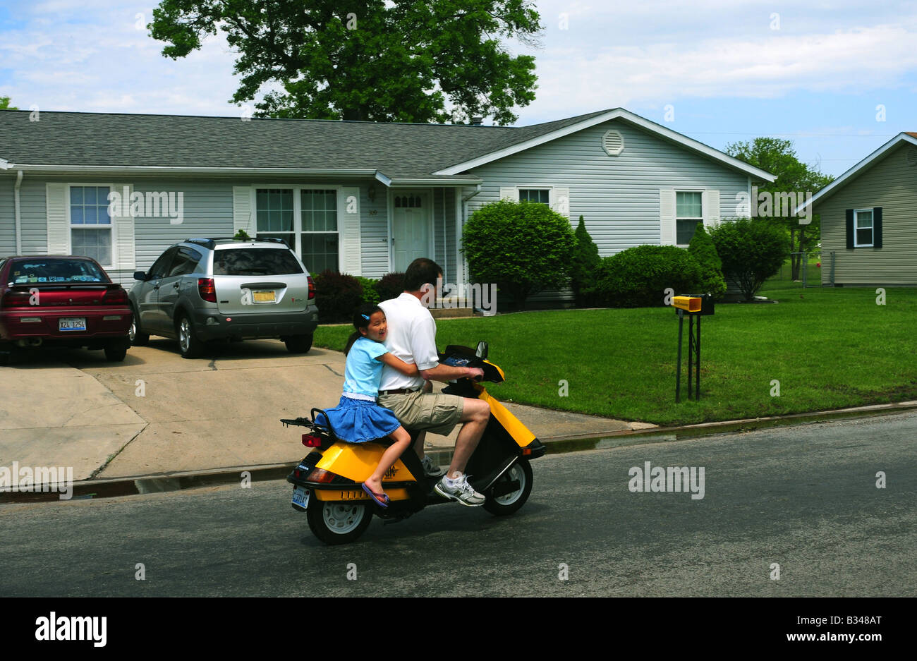 Family and yellow Yamaha scooter cycle Stock Photo - Alamy