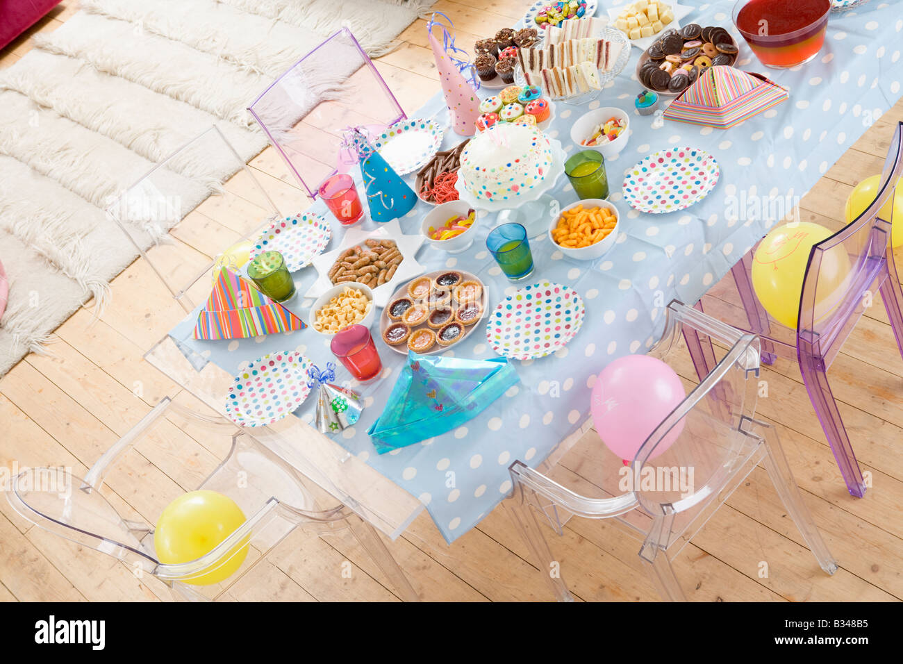 Birthday party table setting with food Stock Photo - Alamy