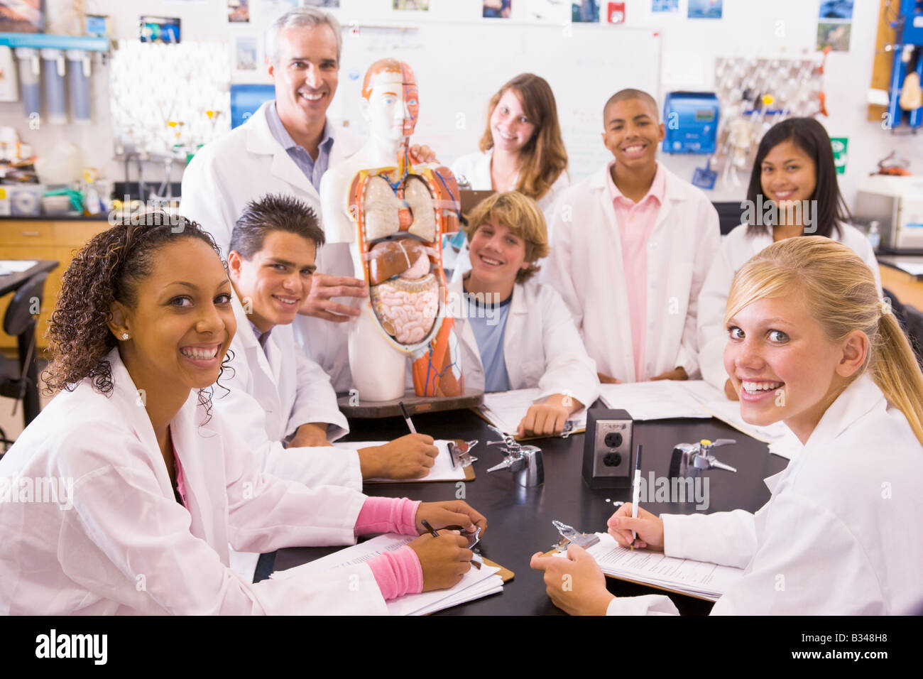 Students in biology class with teacher Stock Photo - Alamy