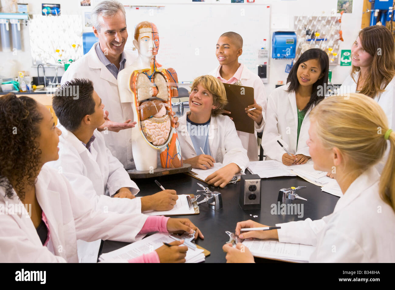 Students in biology class with teacher Stock Photo - Alamy