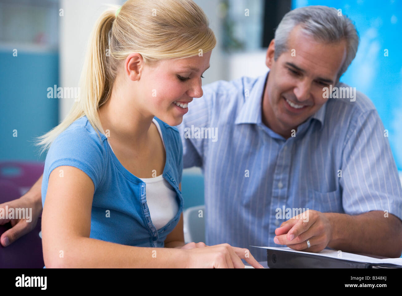Teacher giving personal instruction to female student Stock Photo - Alamy