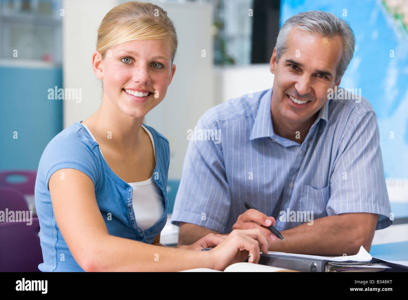 Teacher giving personal instruction to female student Stock Photo - Alamy