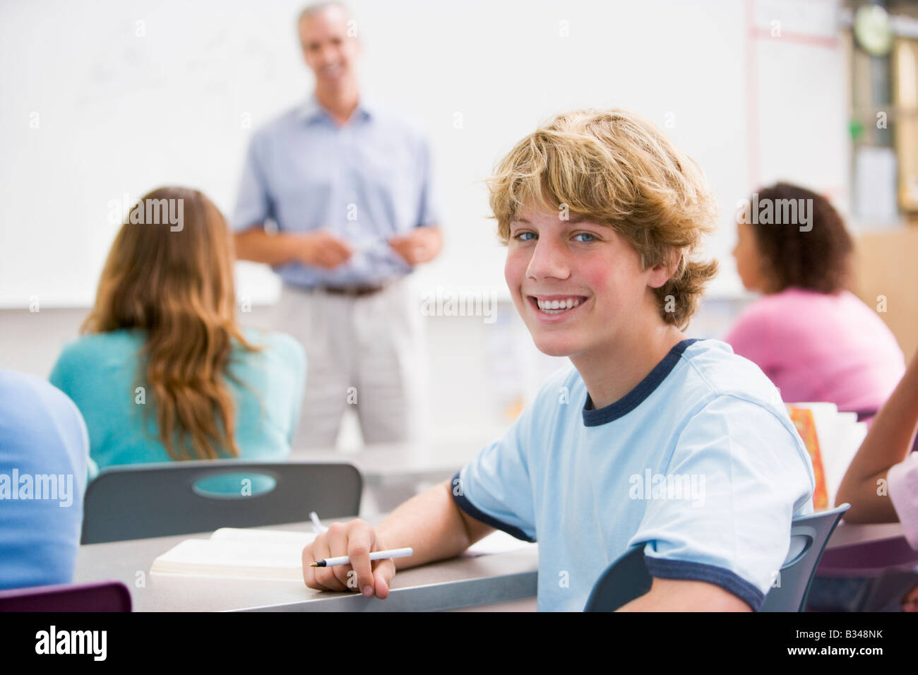 Male student with other students in classroom Stock Photo - Alamy
